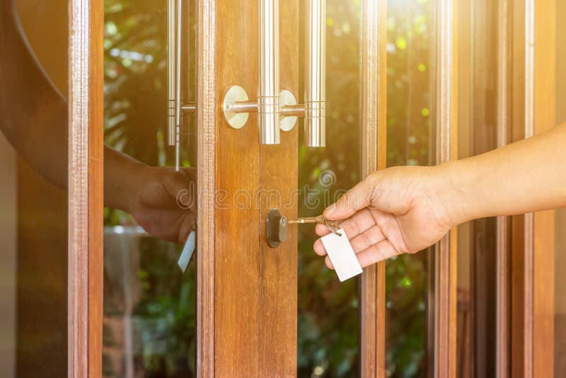 Male Hand Holding a Key in a Keyhole,Hand Holding the Key. Opening the ...