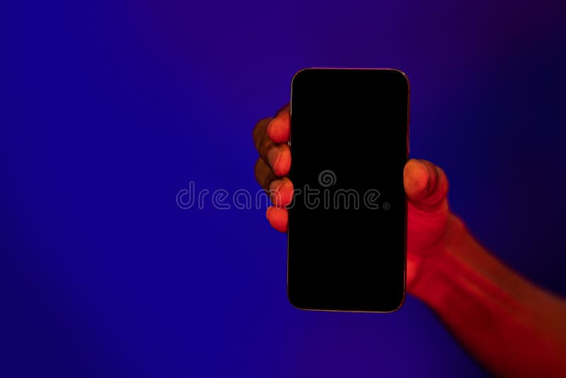 Male Hand Holding Mobile Phone Showing Empty Screen, Blue Background ... Male Hand Holding Mobile Phone Showing Empty Screen, Blue Background ...