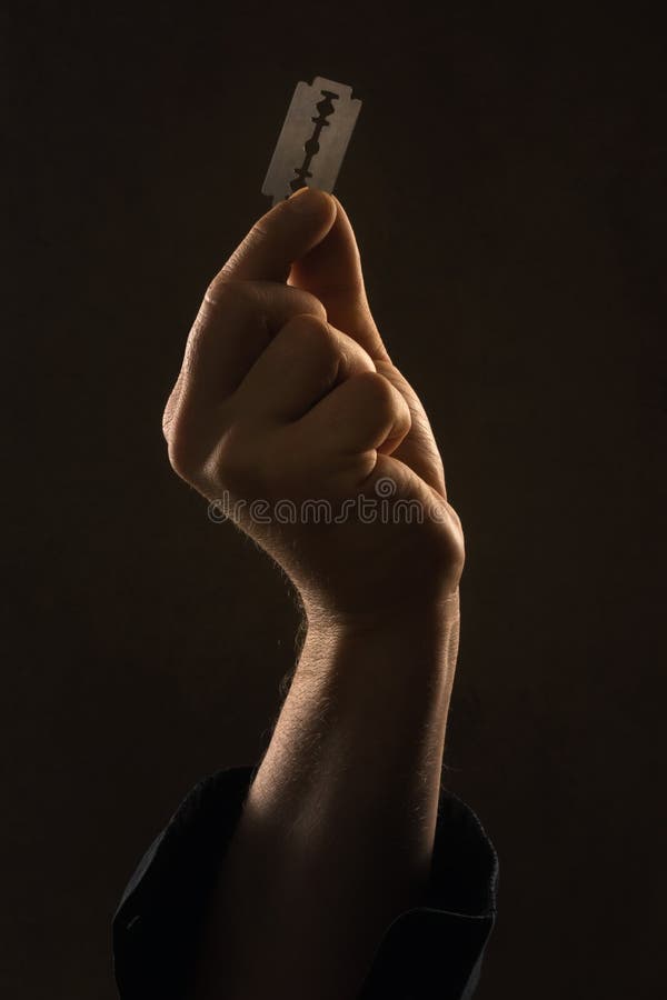 Male Hand Holding a Razor Blade Stock Photo - Image of silhouette ...