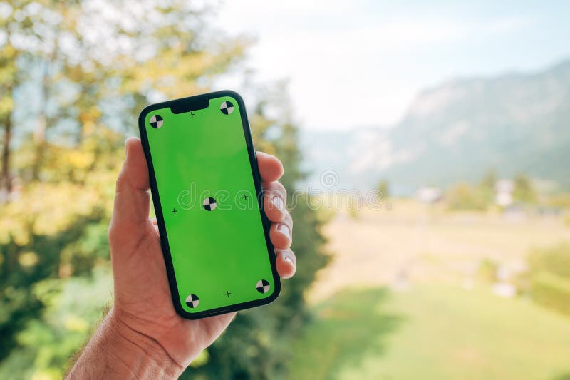 Male Hand Holding Smart Phone with Mockup Green Screen Stock Image ...