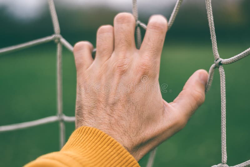 Male Hand Holding Soccer Net Stock Photo - Image of male, football ...