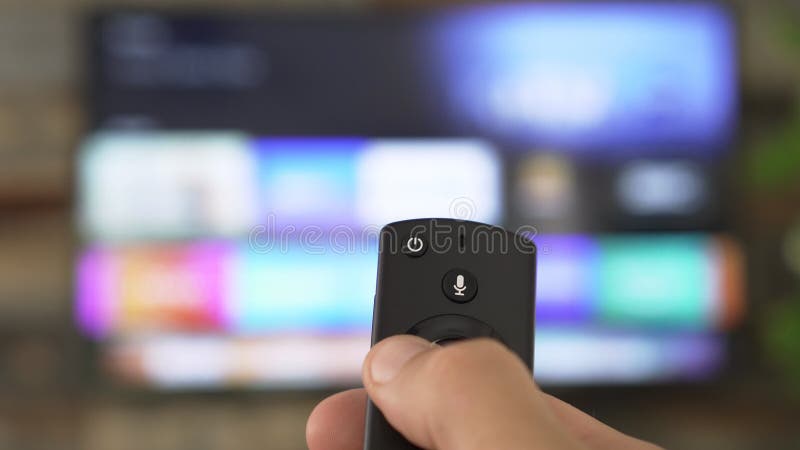 Male Hand Holding the TV Remote Control and Changing TV Channels Stock ...