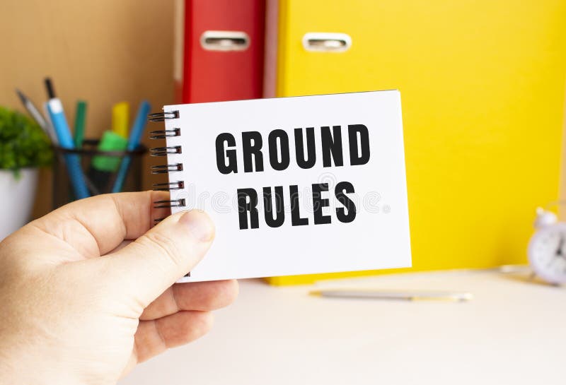 A Male Hand Holds a Notepad on a Spring with the Written GROUND RULES ...