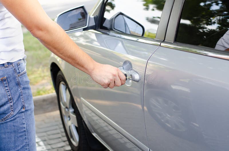 Male Hand Inserting a Key into the Door Lock of a Car Stock Image ...