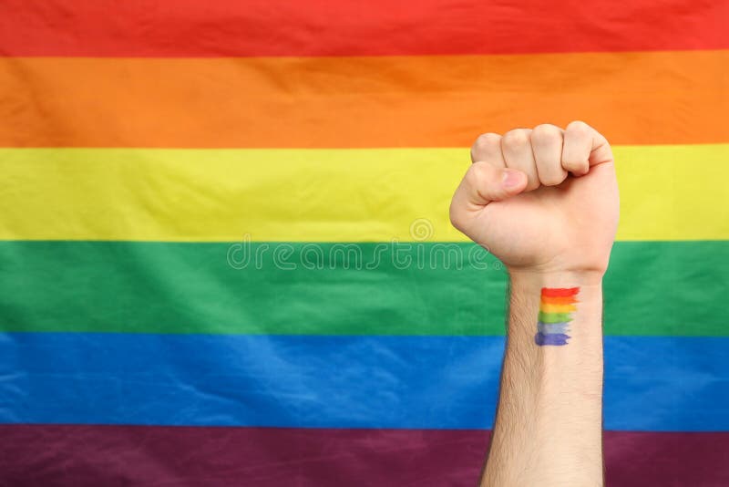Male Hand with LGBT Rainbow Against LGBT Flag Space for Text Stock ...