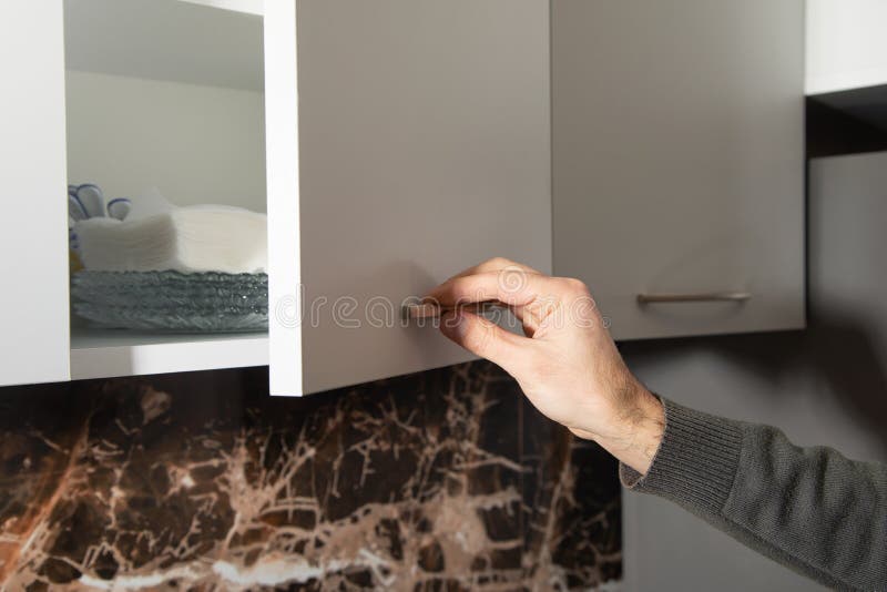 Male Hand Opening Kitchen Cupboard Door Stock Image - Image of storage ...