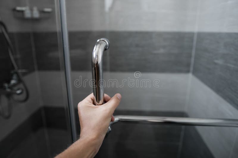Male Hand Opens the Shower Door in a Modern Bathroom. Stock Image ...