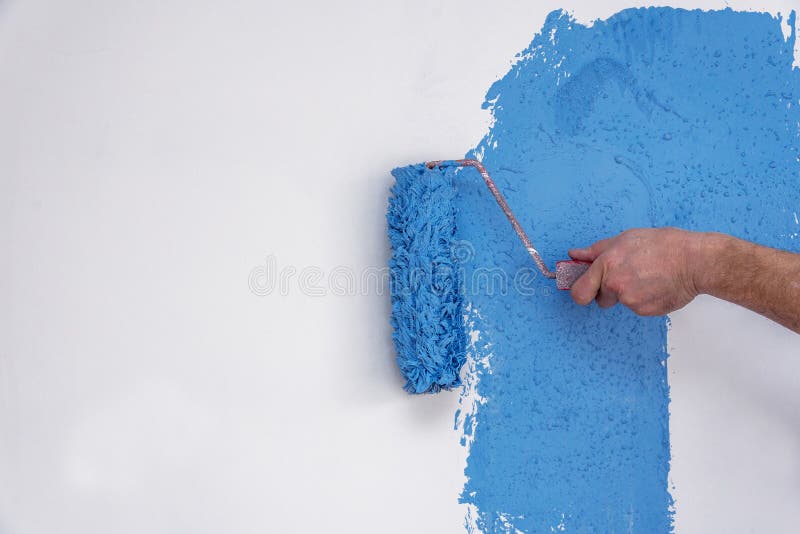 Male Hand Painting Wall in Blue with Paint Roller. Stock Image - Image ...