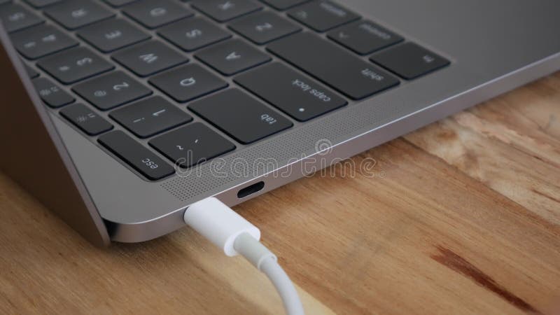 Male Hand Plugging in a White Power USB-C or Type C Cable into a Laptop ...