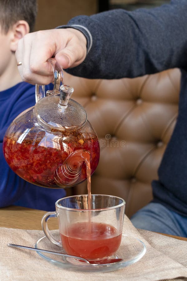 Male Hand Pours Red Tea from a Teapot into a Cup Stock Photo - Image of ...