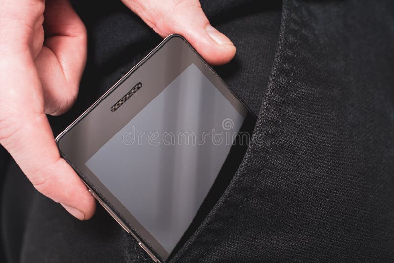 Male Hand Pulling a Black Smartphone with Copy Space Out of a Dark ...