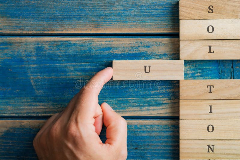 Male Hand Pushing a Wooden Peg into a Stack of Them To Spell the Word ...