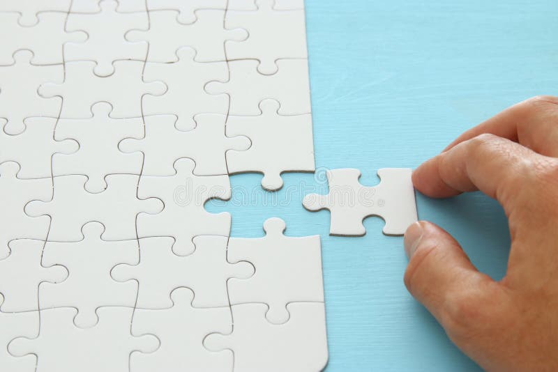 Male Hand Putting the Last Piece in the Puzzle. Stock Image - Image of ...