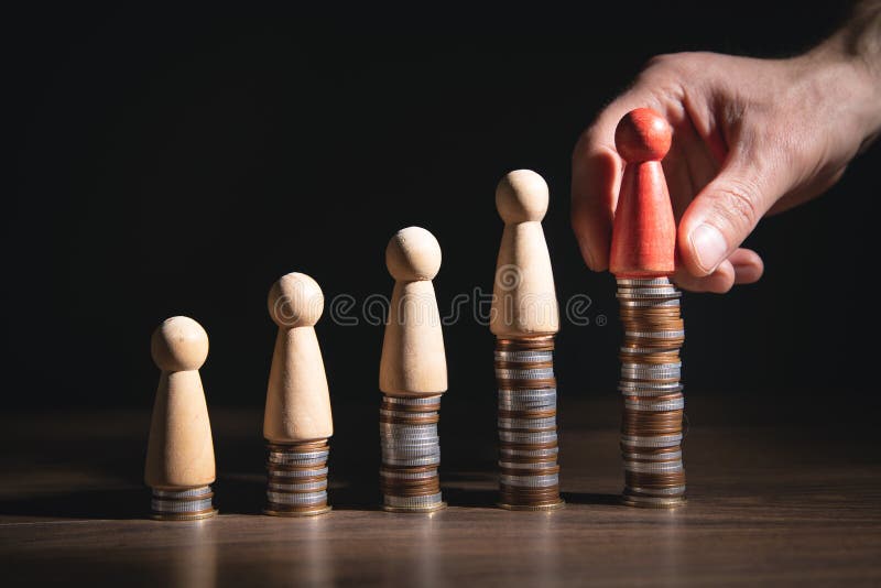 Male Hand Showing Wooden Human Figure on Coins Stack Stock Photo ...