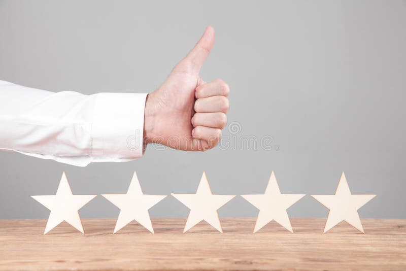 Male Hand Shows Thumb Up and Five Star Rating Stock Photo - Image of ...
