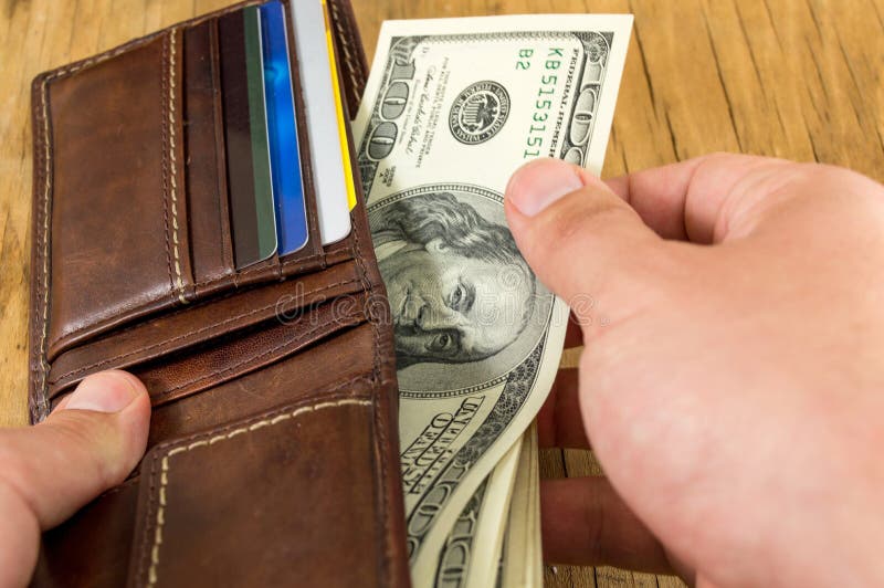 Male Hand Taking Dollar Out of Wallet Stock Photo - Image of earingn ...