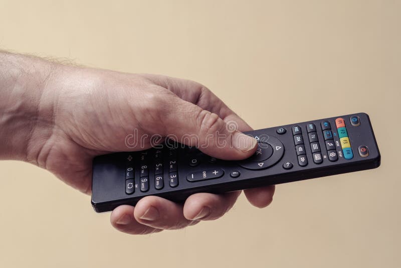Male Hand with a TV Remote Control Close-up. the Man Turns on the TV ...