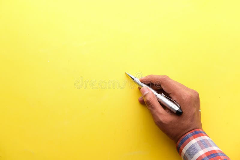 Male Hand Writing on a Blank Yellow Surface with Pen. Stock Photo ...