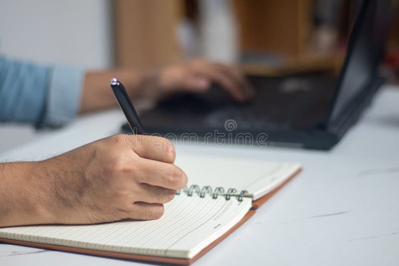 Male Hand Writing a Note in a Notebook Concept of Business People ...
