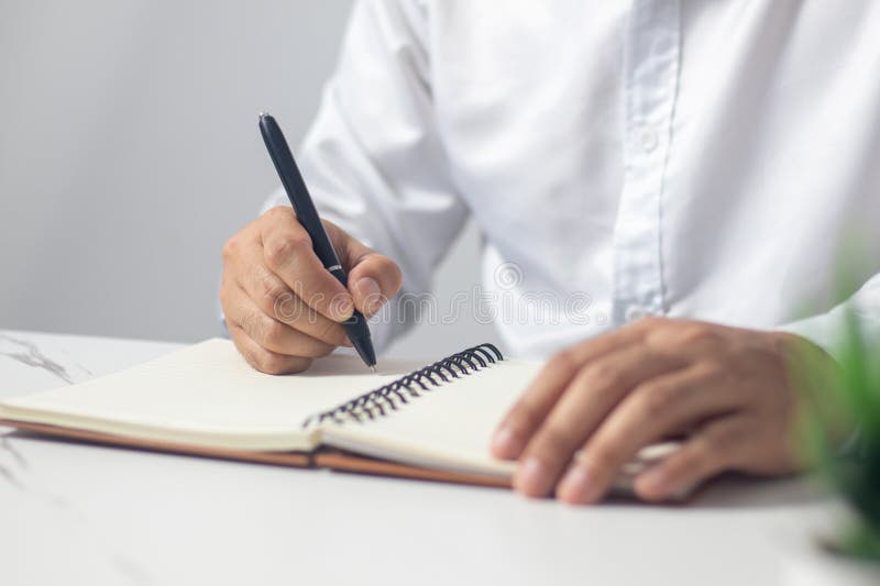 Male Hand Writing a Note in a Notebook Concept of Business People ...