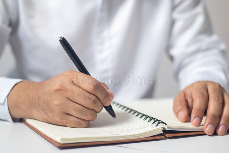 Male Hand Writing a Note in a Notebook Concept of Business People ...