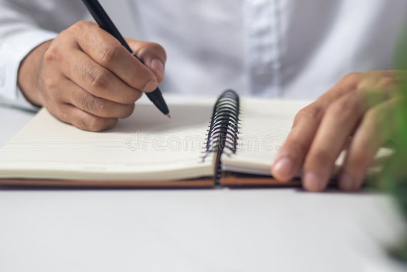 Male Hand Writing a Note in a Notebook Concept of Business People ...