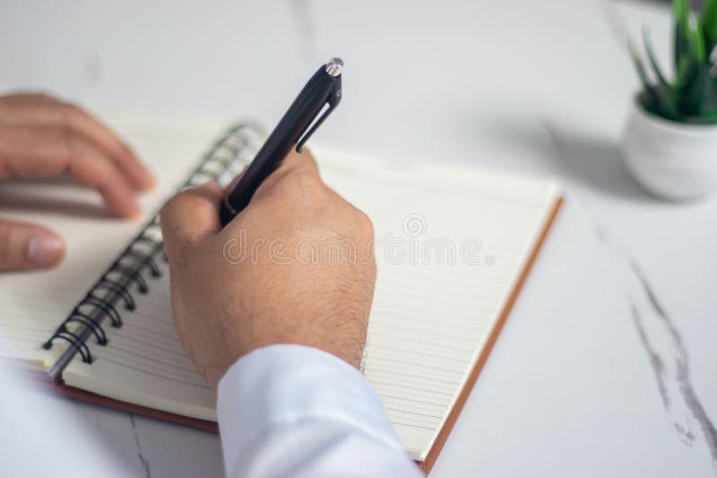Male Hand Writing a Note in a Notebook Concept of Business People ...