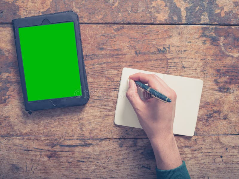 Male Hand Writing in Notepad and Using Tablet Stock Photo - Image of ...