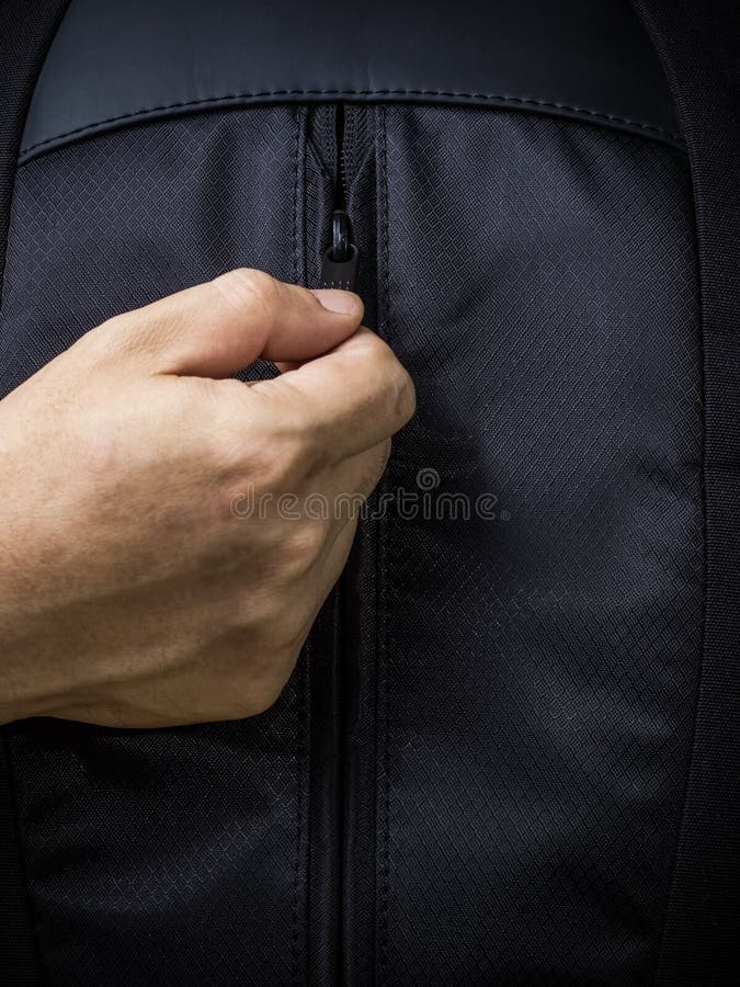 The Man`s Hand Zips Zip Up on the Jacket. Zipper Close Up in Hard Light ...