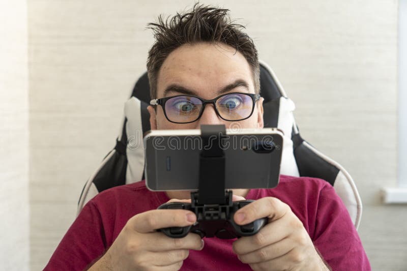 Male Hands with Game Controller Connected with Smartphone. Electronic ...