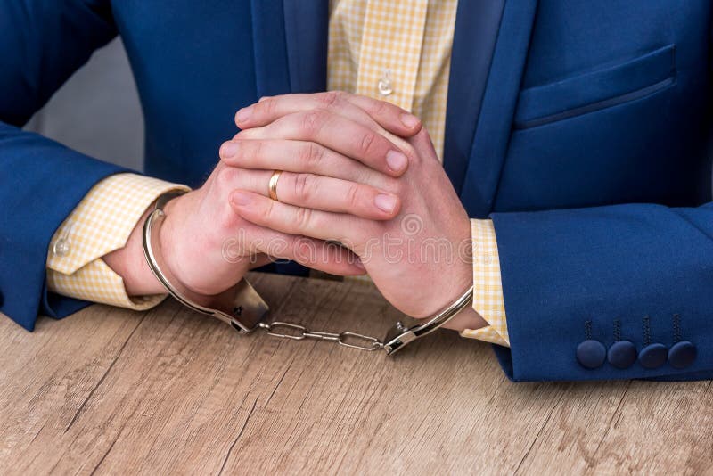 Male Hands in Handcuffs on Wooden Table Stock Image - Image of handcuff ...