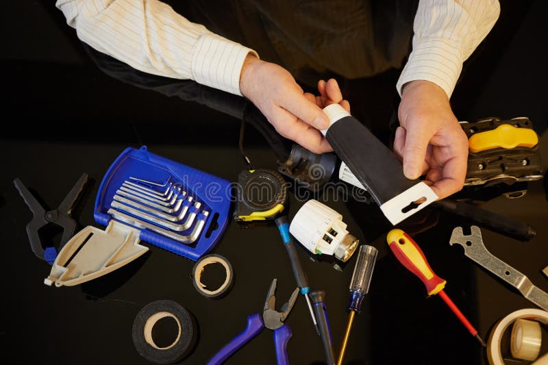 Male Hands Hold Black Tube Above Table with Stock Photo - Image of ...