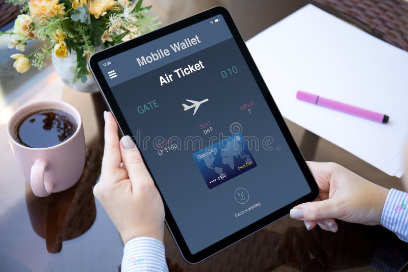 Male Hands Holding Computer Tablet with Airplane Ticket Application ...