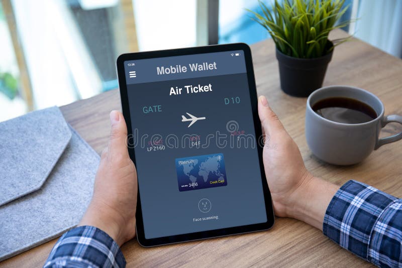 Male Hands Holding Computer Tablet with Airplane Ticket Application ...