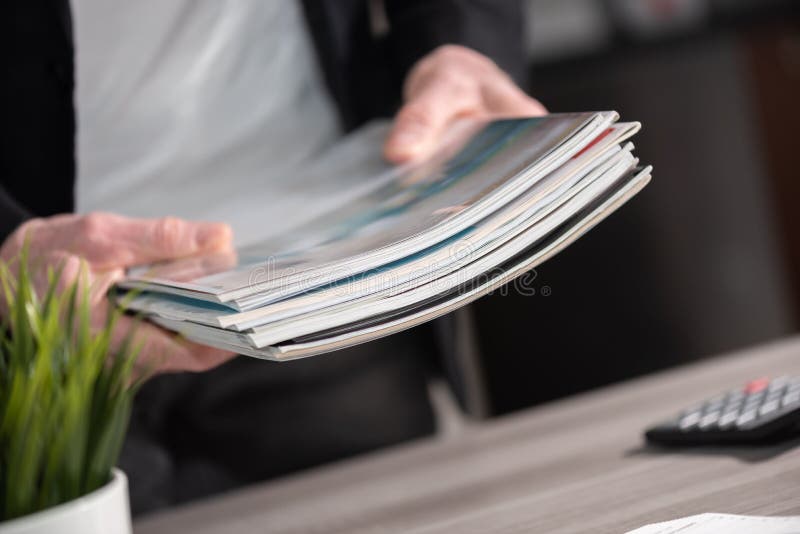Male Hands Holding Magazines Stock Image - Image of holding, heap ...