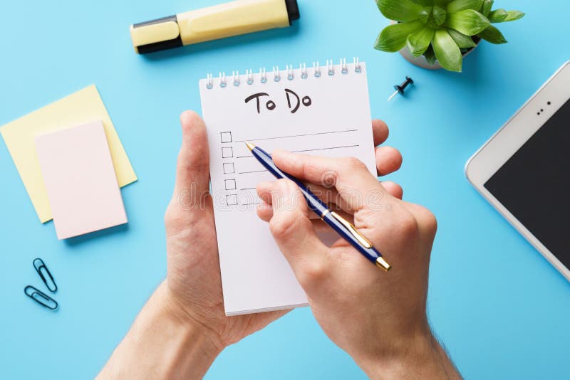 Male Hands Making a To-do List in a Notebook Over an Office Desk Stock ...