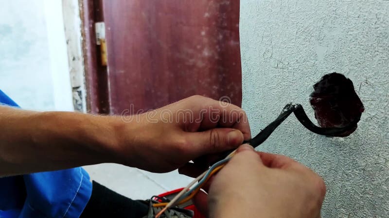 The Male Hands of the Master Prepare a Cable with Wires for Connecting ...
