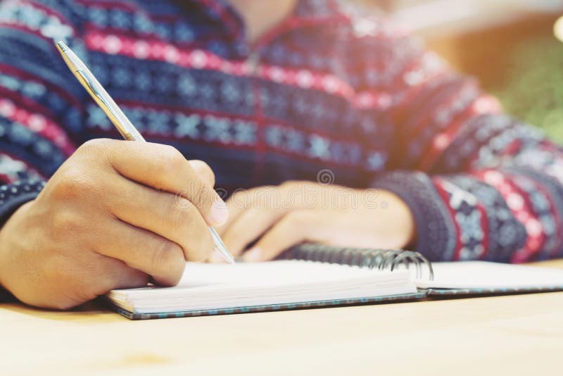 Male Hands with Pen Writing on Notebook Notepad Sitting in Public Park ...