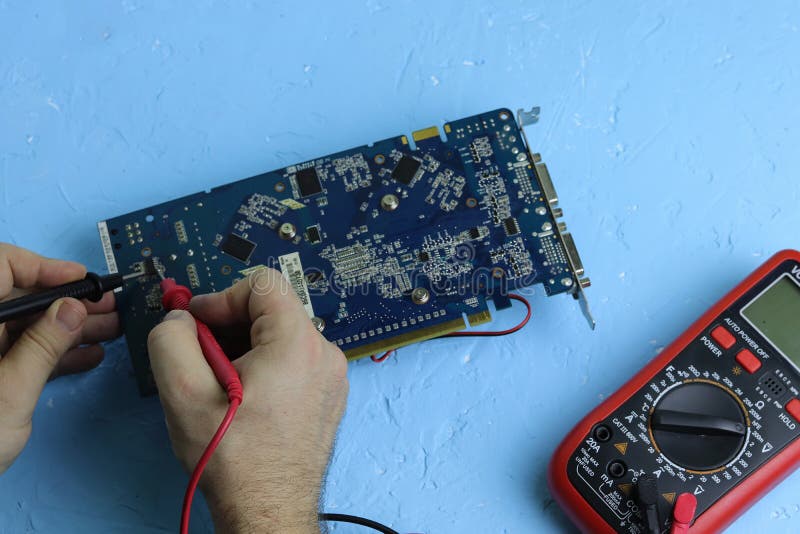 Male Hands Repair an Electronic Device Using Multimetr, Measuring the ...