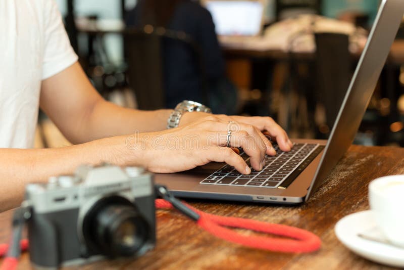 Male Hands Typing on Laptop Keyboard with Camera on Table. Stock Image ...