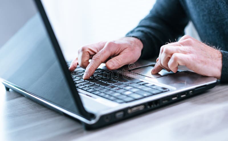 Male hands using a laptop stock photo. Image of office - 141301110