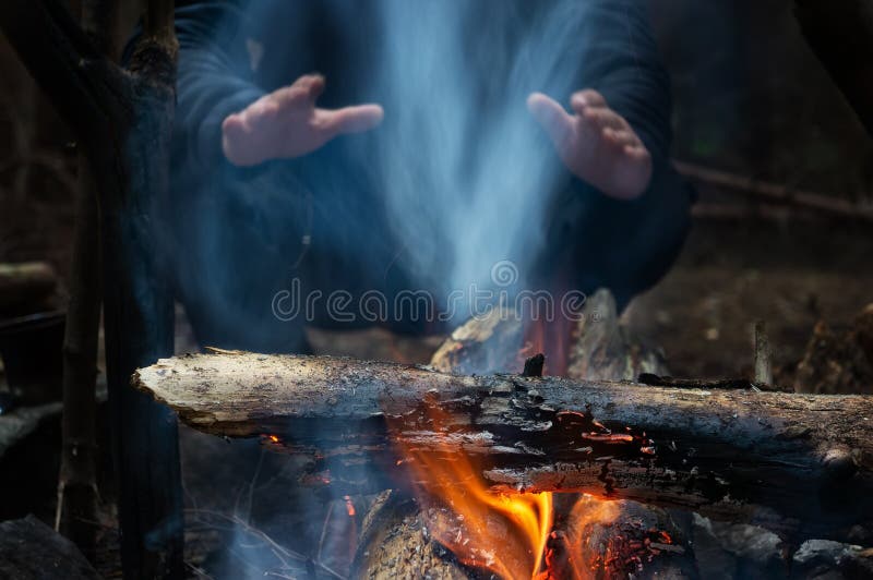 Male Hands are Warming by the Fire. a Hot Fire in the Camp Keeps ...