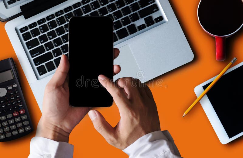 Male Hands Working on Modern Smartphone and Laptop. Office Desktop ...