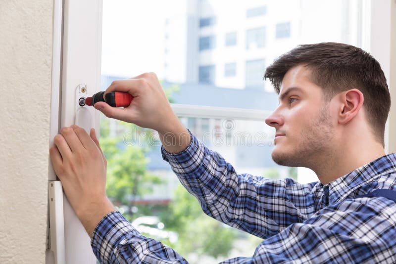 Handyman Fixing Window with Screwdriver Stock Photo - Image of insulate ...