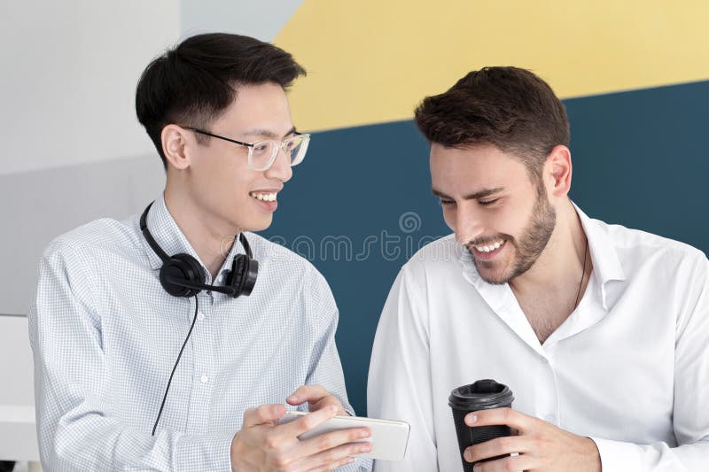 Male Helpdesk Operators with Hot Takeout Coffee Browsing Web on ...