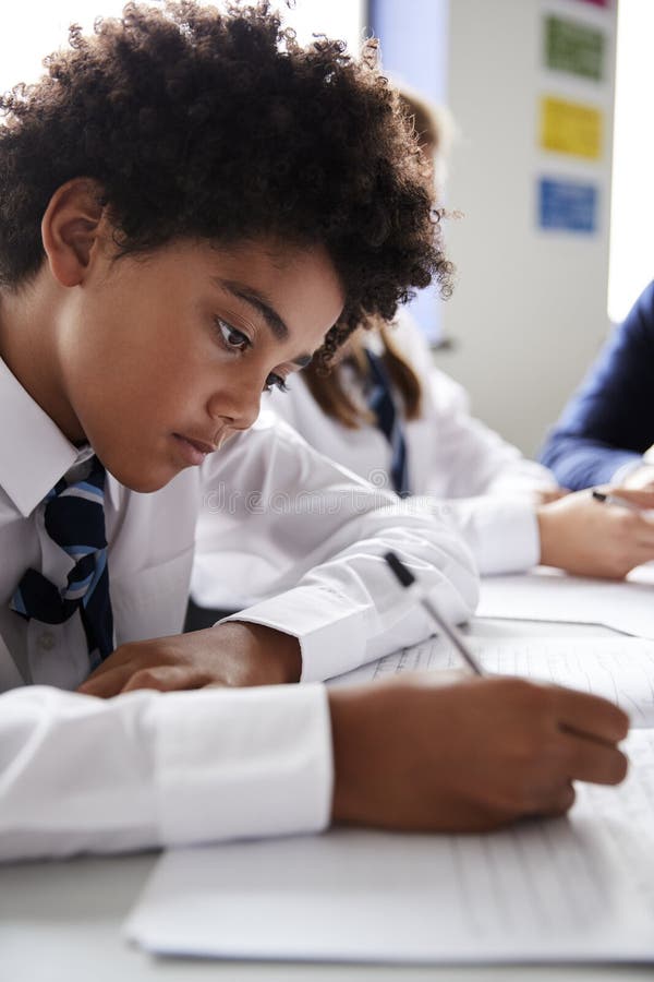 Male High School Student Wearing Uniform Working at Desk Stock Photo ...
