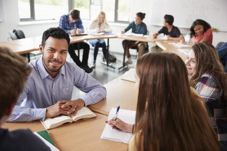 Male High School Tutor with Pupils Sitting at Table Teaching Maths ...