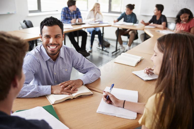 Male High School Tutor with Pupils Sitting at Table Teaching Maths ...