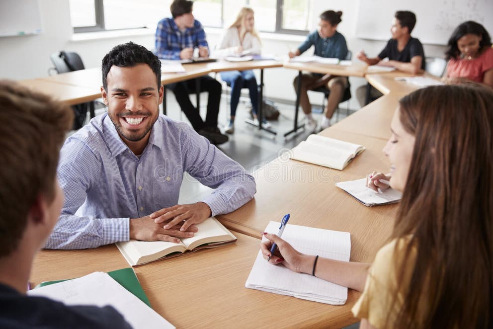 Male High School Tutor with Pupils Sitting at Table Teaching Maths ...