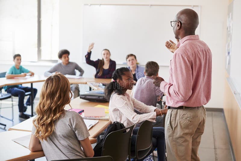 Male High School Tutor Standing at Whiteboard Teaching Class Stock ...